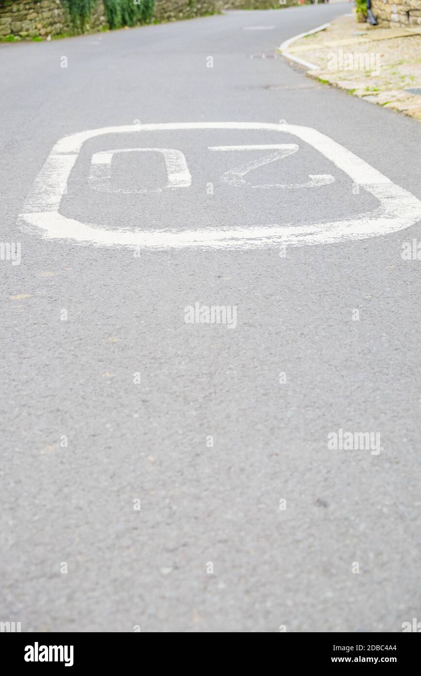 a speed limit sign painted on the road UK Stock Photo - Alamy