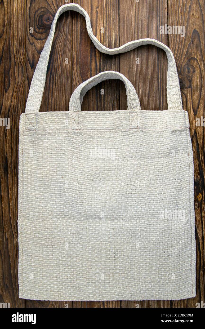Eco friendly canvas shopping white bag on the dark wooden table ...