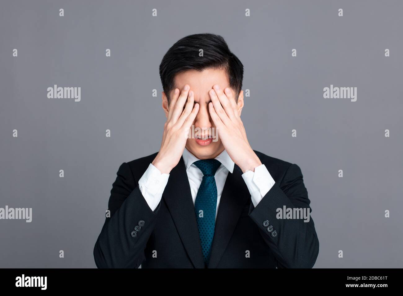 Stressed young business man hand cover eye Stock Photo - Alamy