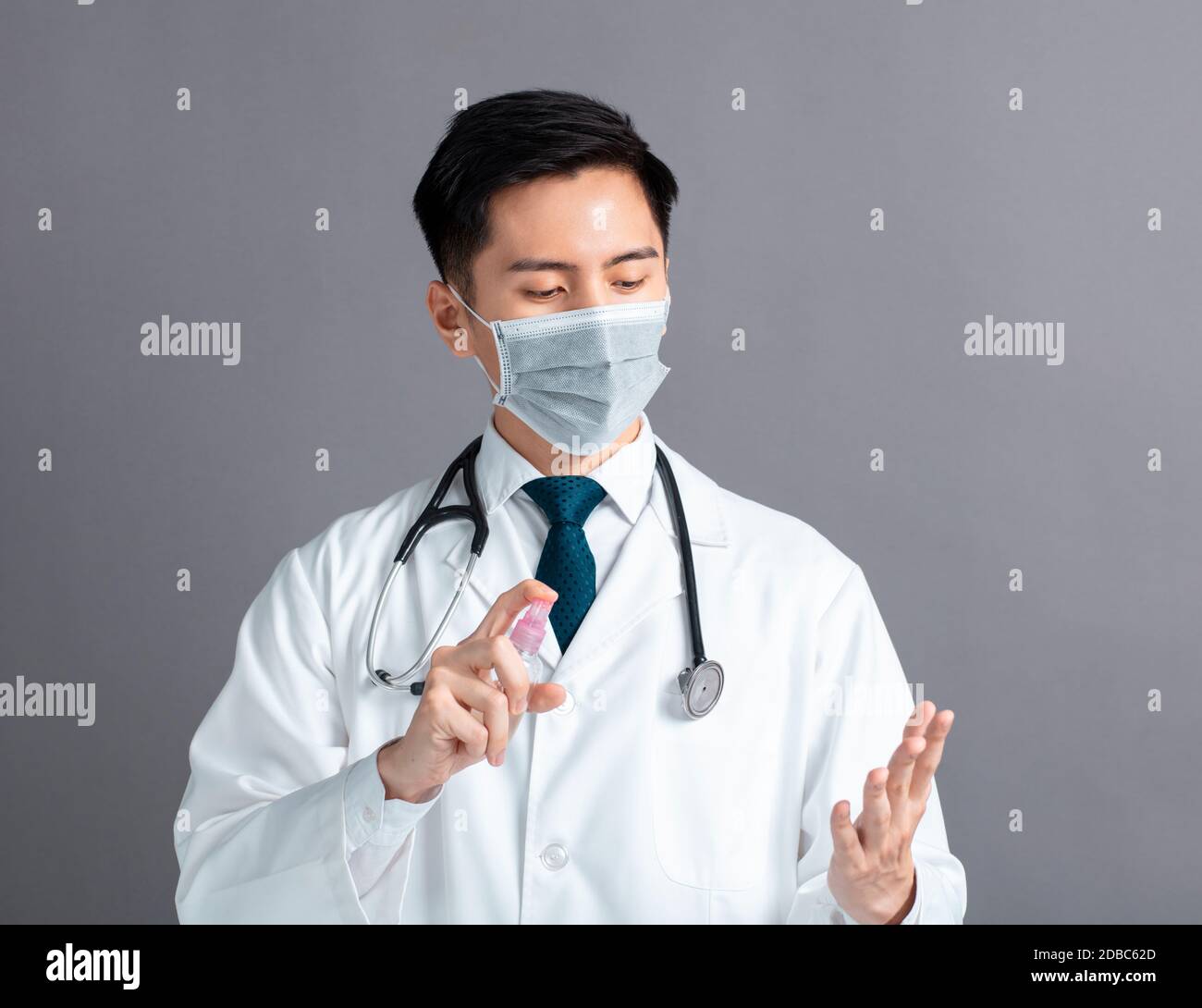 male doctor in uniform puts a disinfecting soap on her hands Stock ...