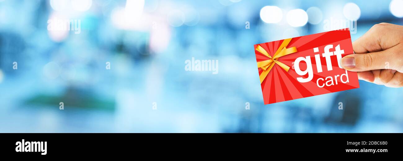 Hand giving gift voucher hi-res stock photography and images - Alamy