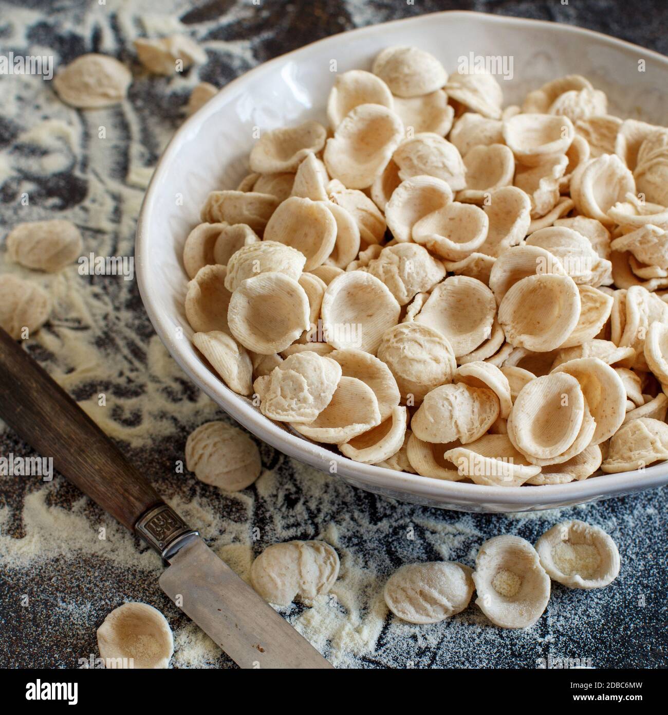 Fresh raw apulian pasta orecchiette made from whole wheat flour on a ...
