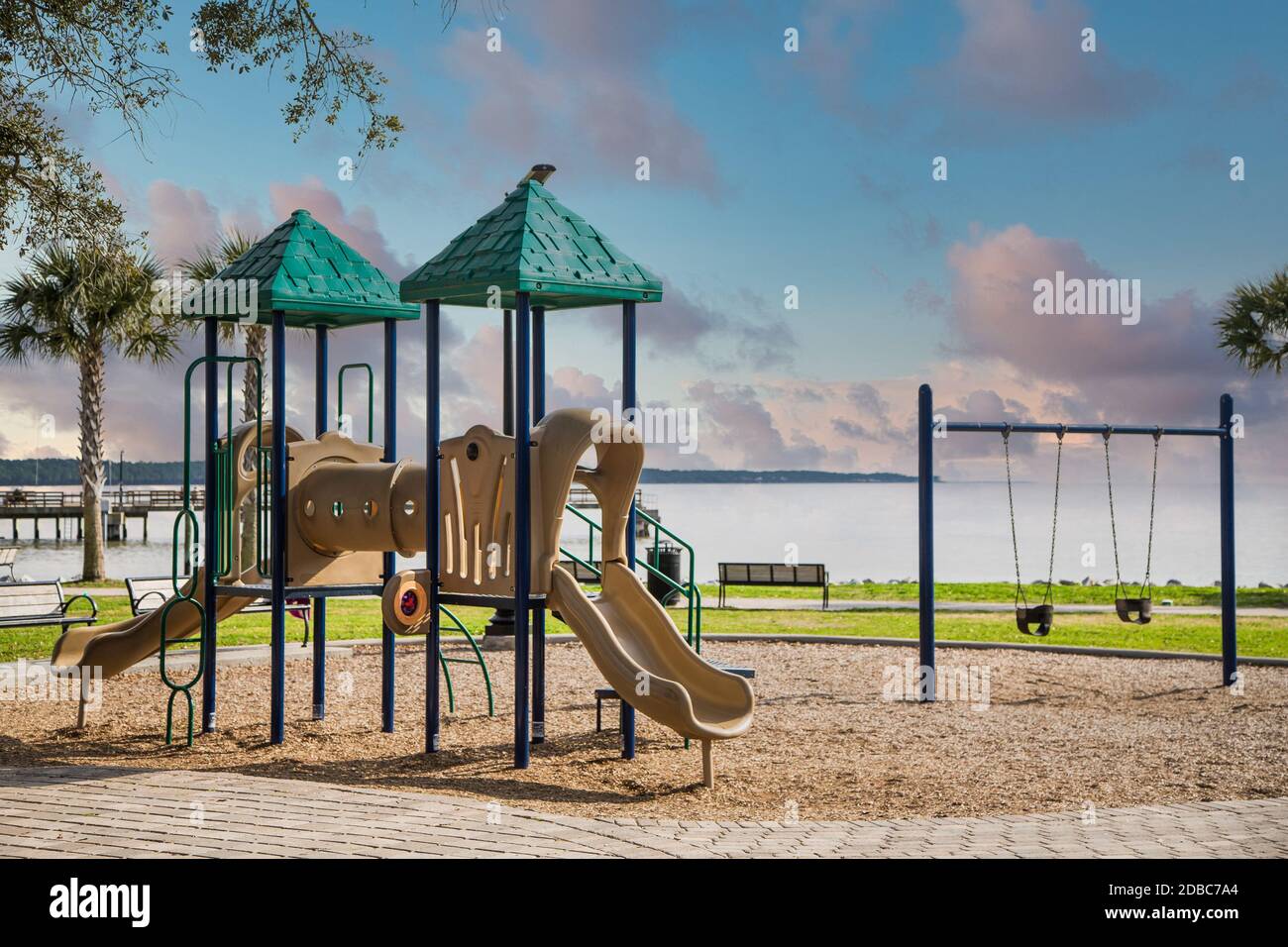 A colorful playground with swings and a sliding board in a park by the ...