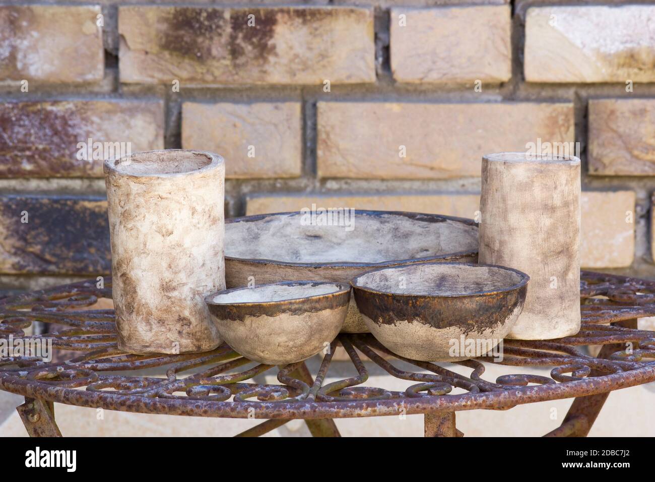 clay pots on a metal table - handmade pottery Stock Photo - Alamy