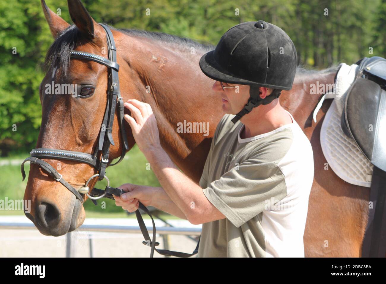 Man with horse is going for a ride Stock Photo - Alamy