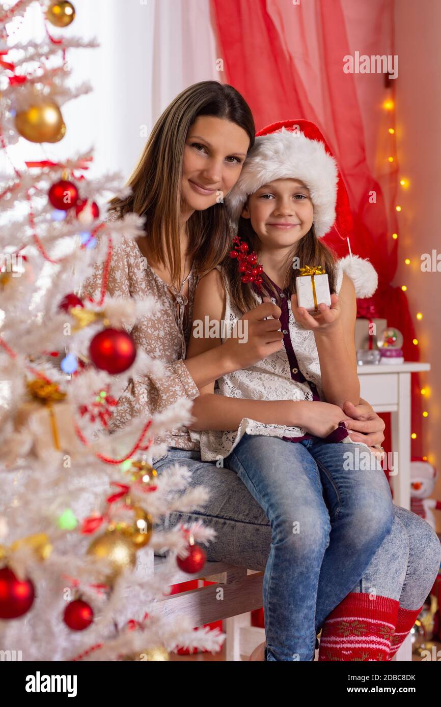 happy mom and daughter sit in a beautifully decorated room near a ...