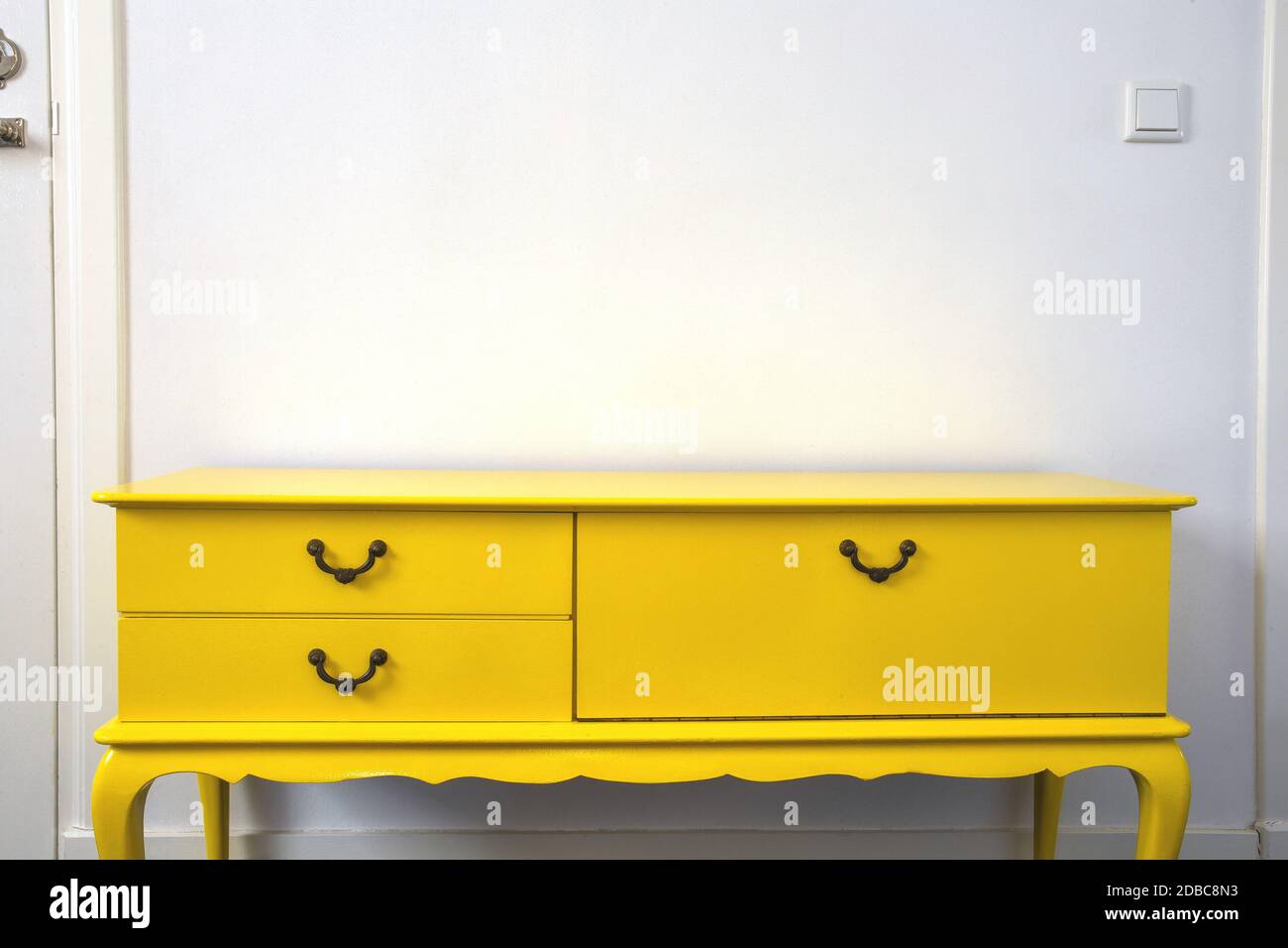 Still life of vintage retro yellow cupboard with white wall, modern ...