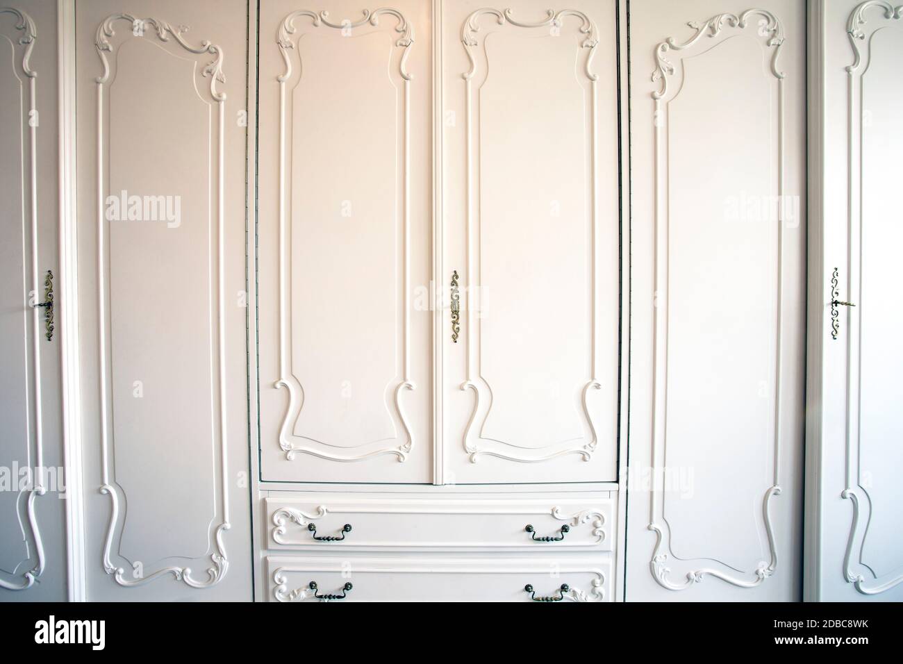 White cupboard doors with Golden key in keyhole, luxury antique design ...