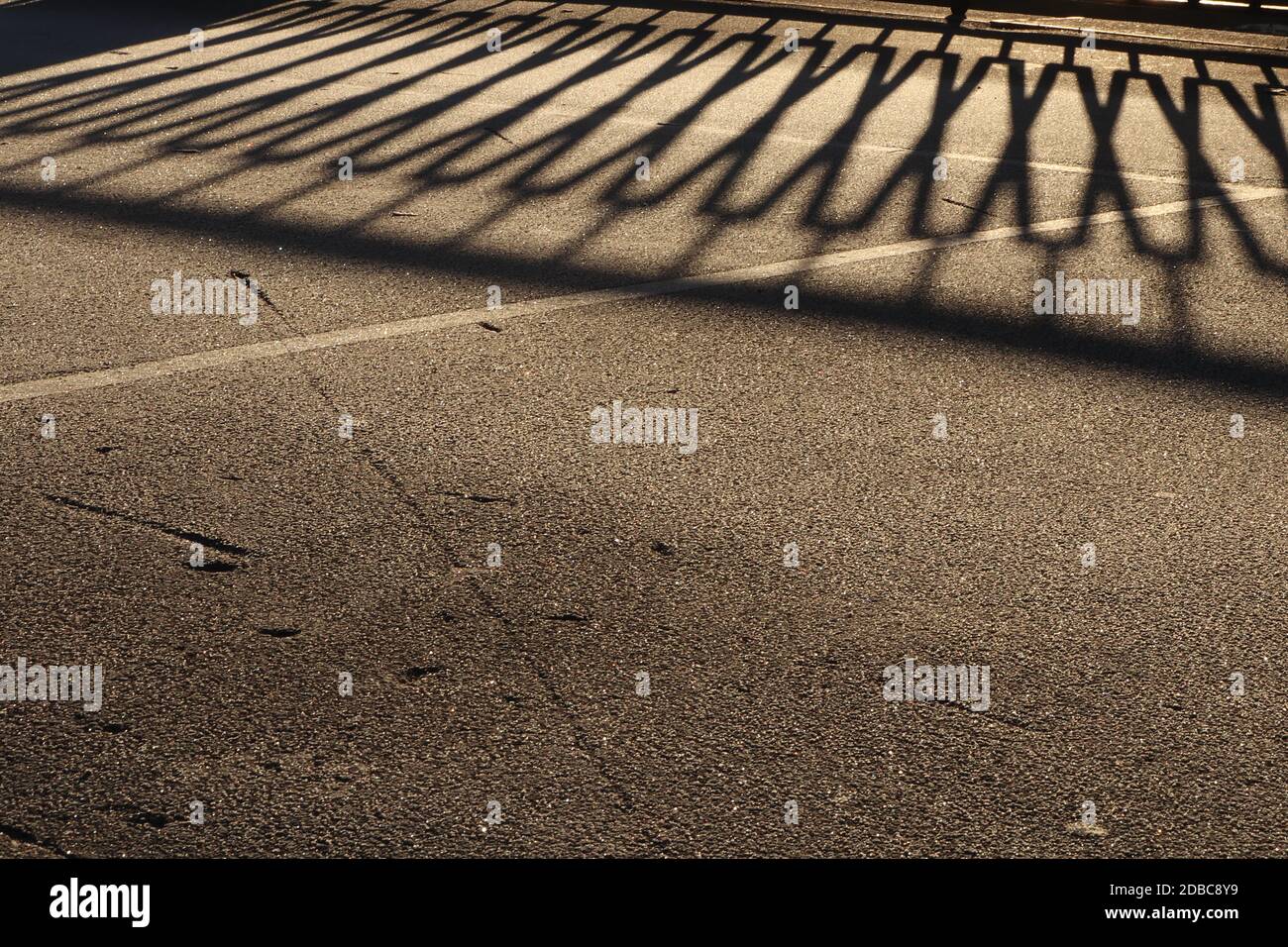 Guardrail Shadow on Icy Asphalt Road Surface. Urban Street Background ...