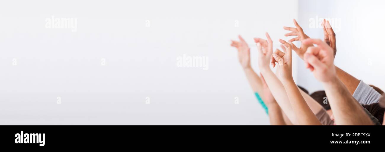 Hands Raising To Ask Question In Class Stock Photo - Alamy