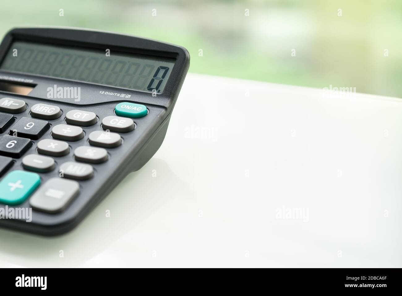 Calculator on the white table near window, closeup sideview isolated ...
