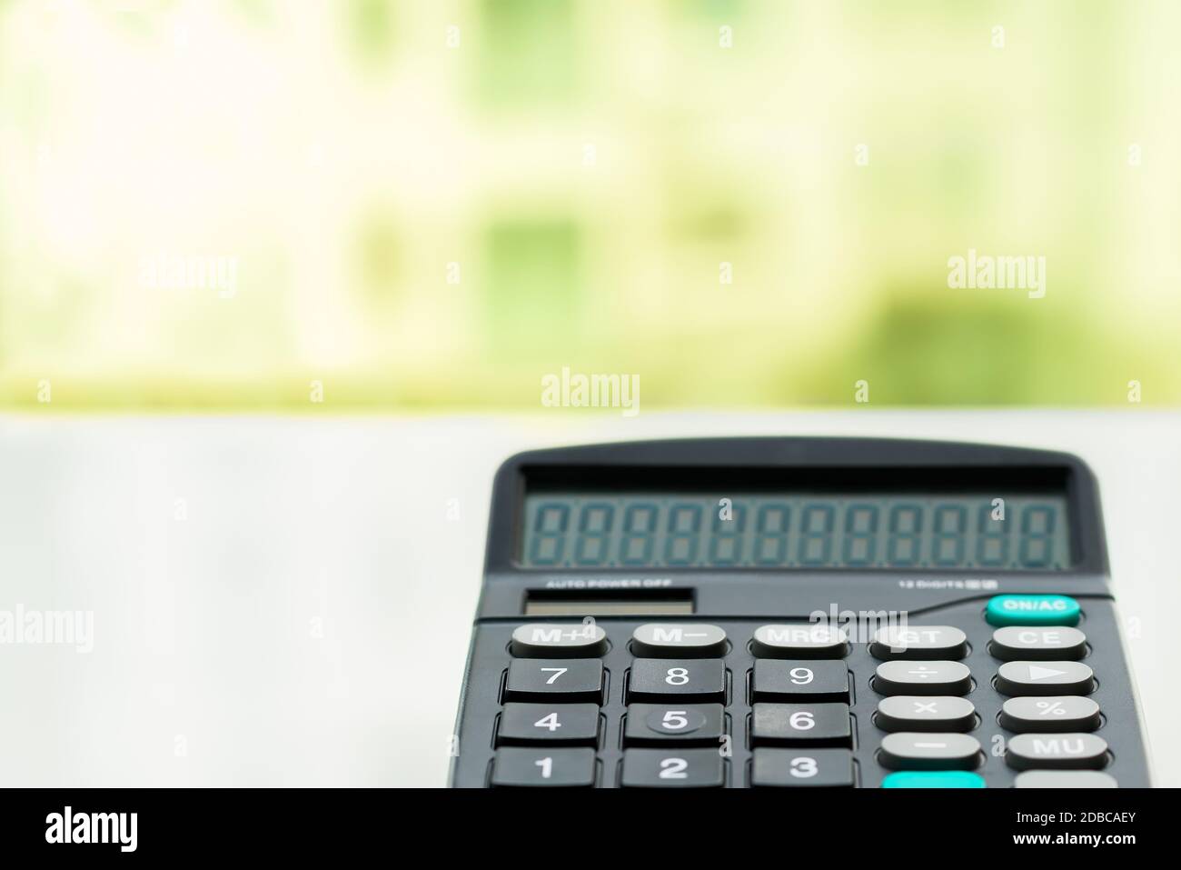 Calculator on the white table near window, closeup sideview isolated ...