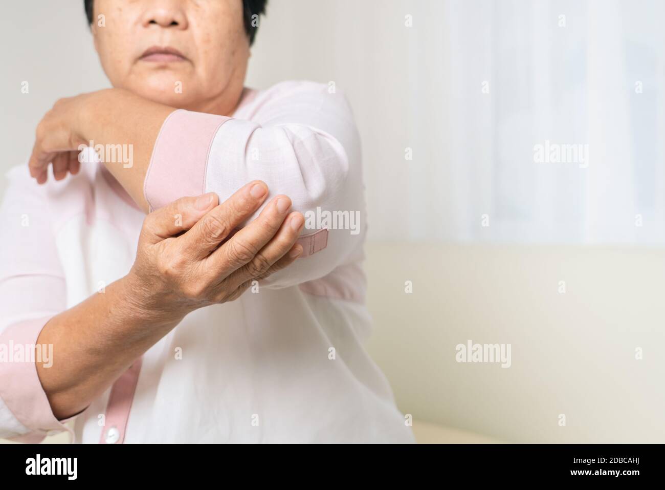 elbow pain old woman suffering from elbow pain at home, healthcare ...