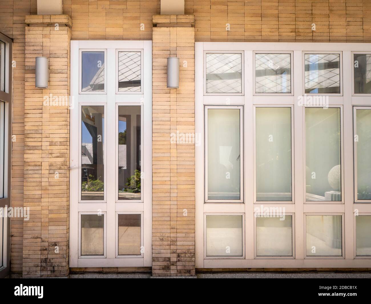 Glass windows and doors with turquoise frames at red bricked Stock ...