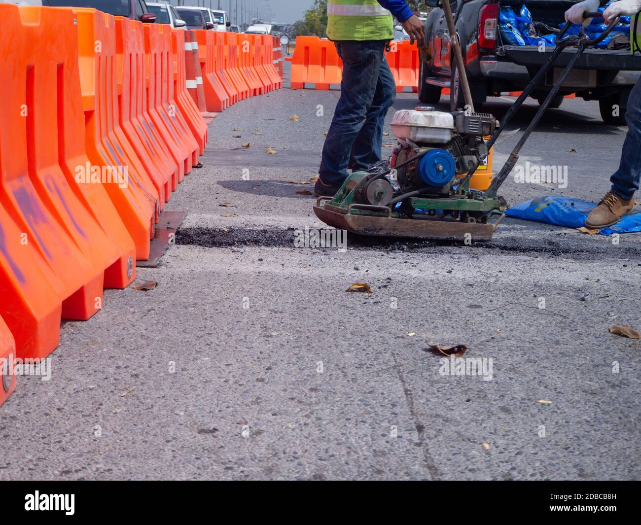 Vibratory plate compactor compacting asphalt hi-res stock photography ...