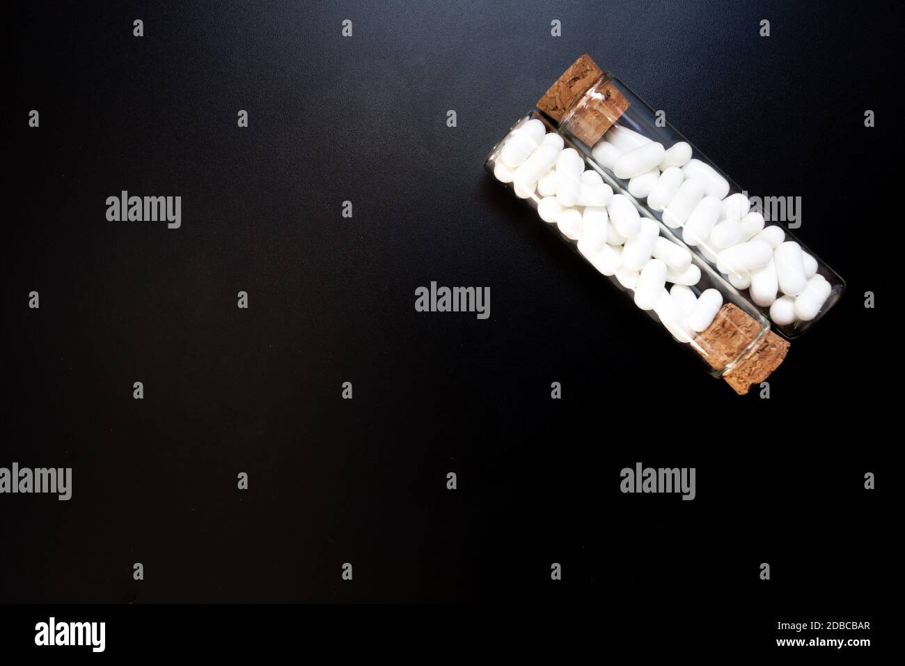 Jordan almonds in glass tube. Wedding decoration on black background ...