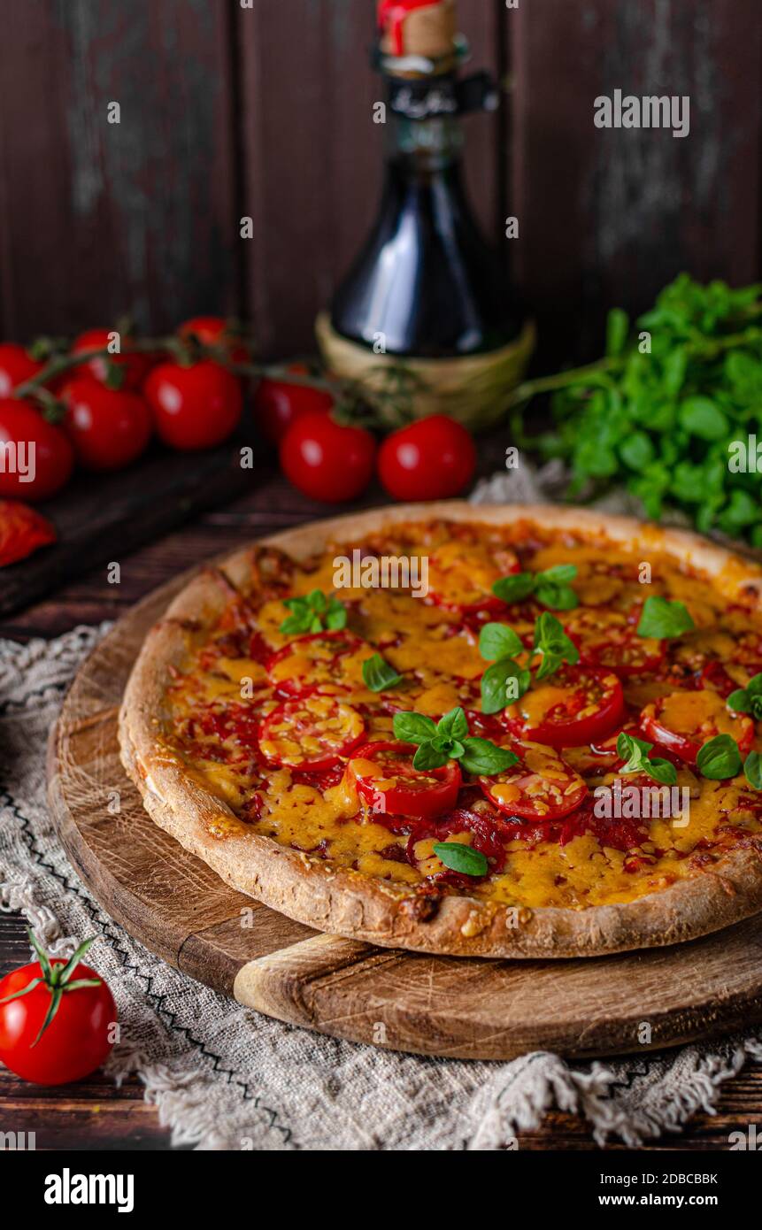 Rustic homemade pizza with sharp cheddar chesse and spicy salami Stock ...