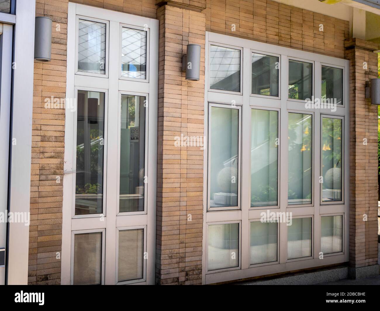 Glass windows and doors with turquoise frames at red bricked Stock ...