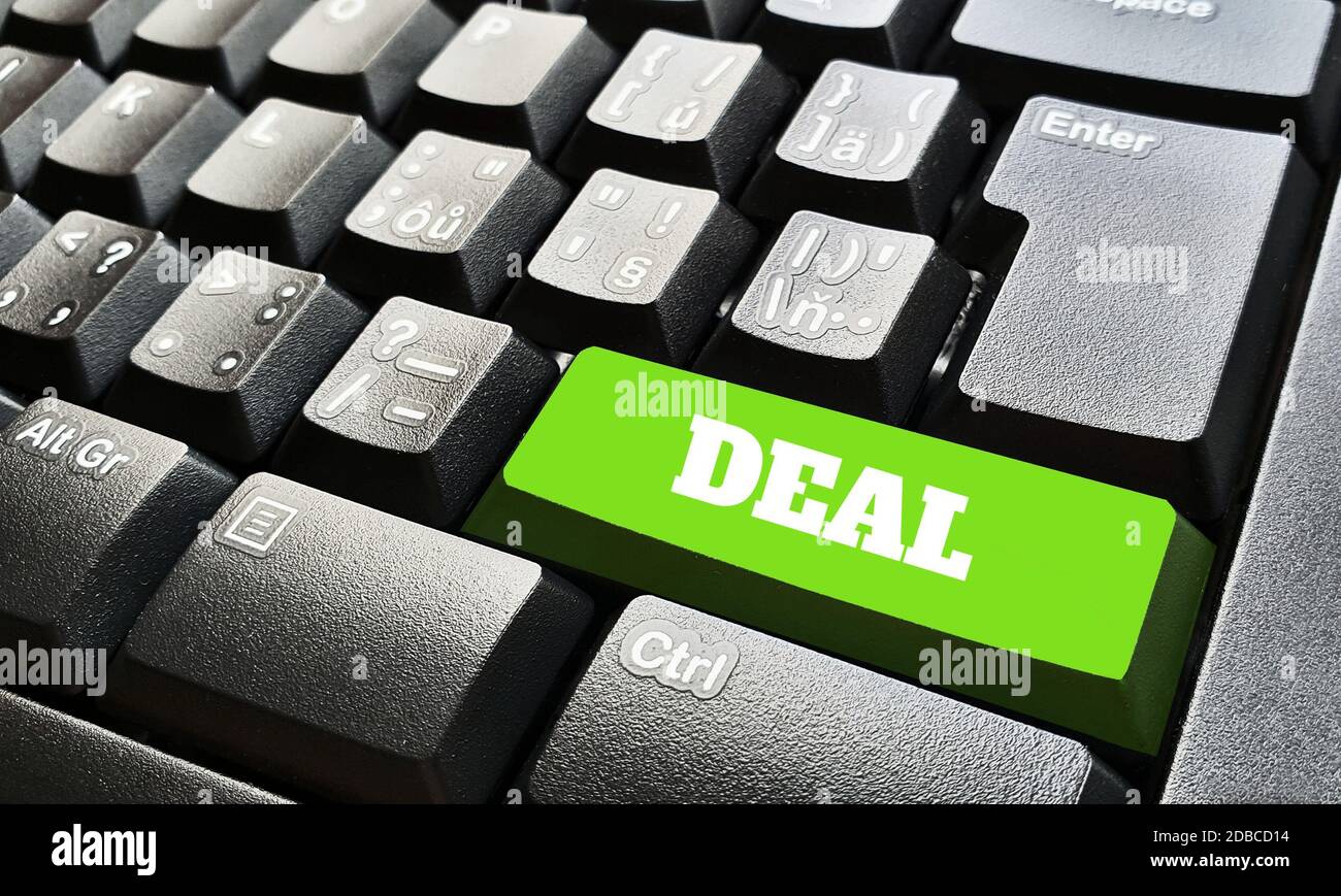 Black keyboard with one green key labeled by deal sign Stock Photo - Alamy