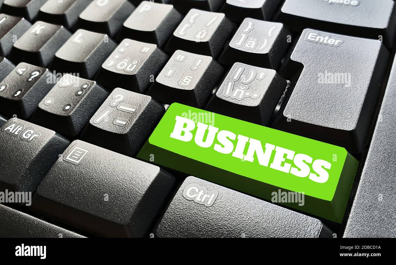 Black keyboard with one green key labeled by business sign Stock Photo ...