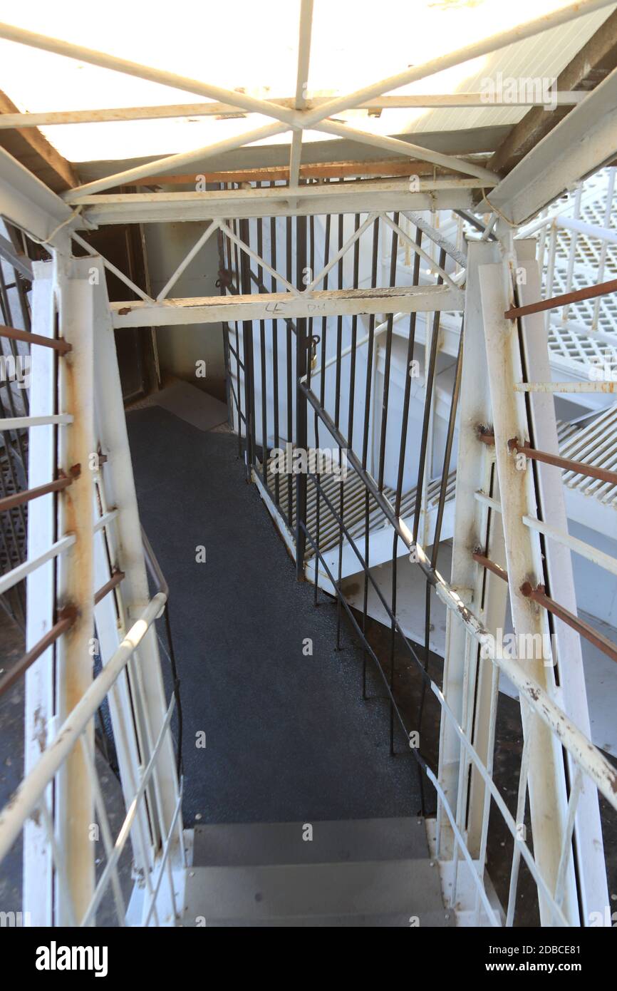 Iron ladder down protected by a cage of steel rods Stock Photo - Alamy