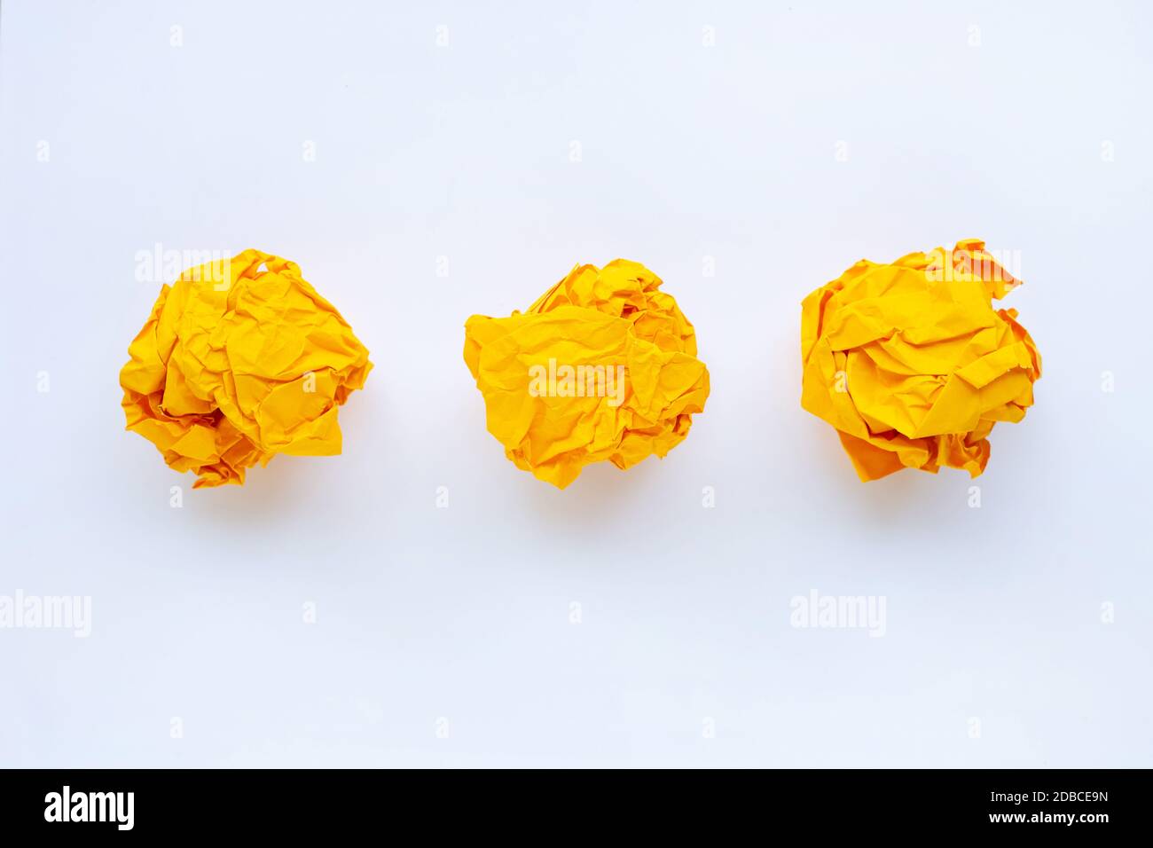 Yellow crumpled paper ball isolated on white background Stock Photo - Alamy