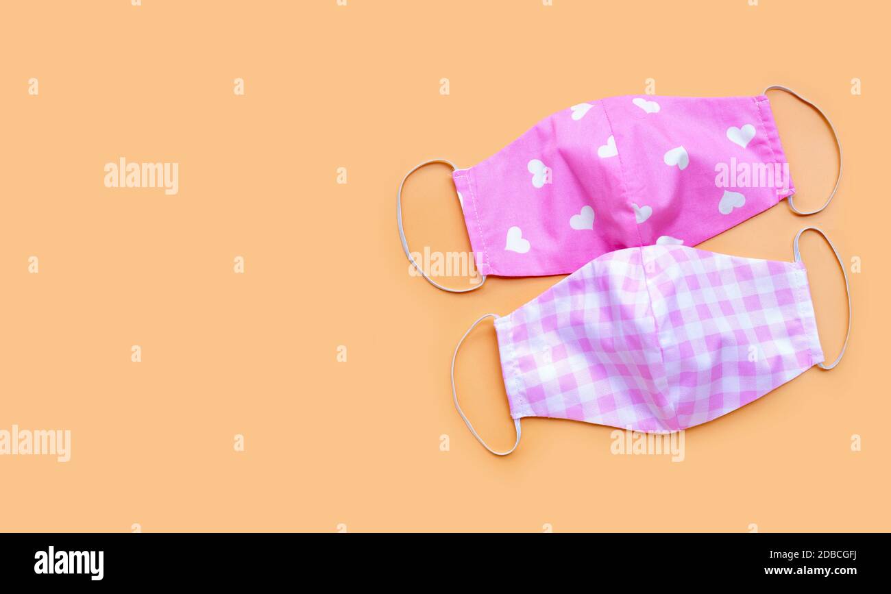 Handmade pink cloth masks on cream color background. Copy space Stock ...