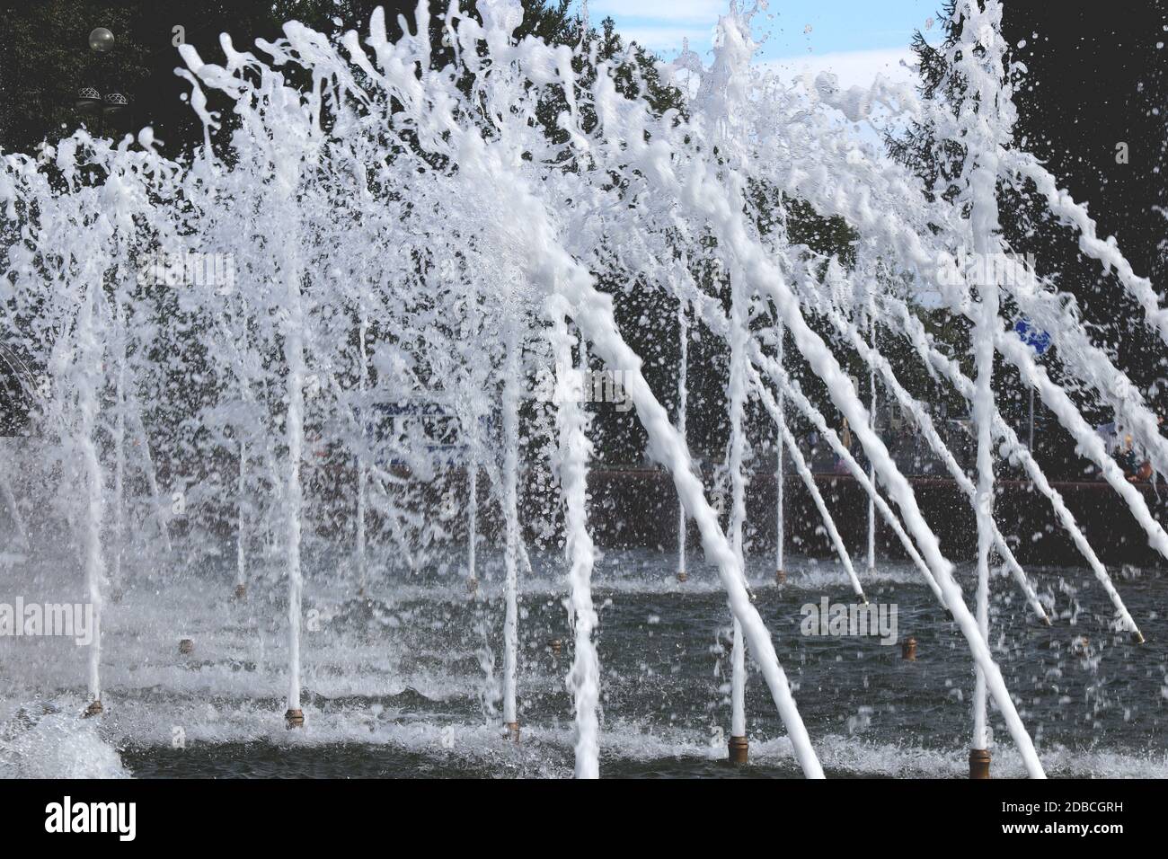 Fountain water streams dynamic motion. Wet spray summer waterfall Stock ...