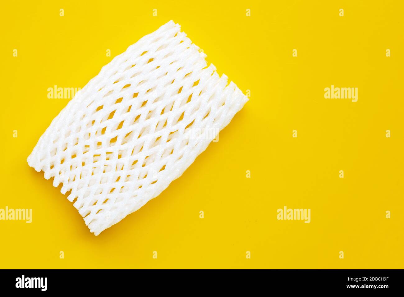 Fruit foam net for protection on yellow background. Top view Stock ...