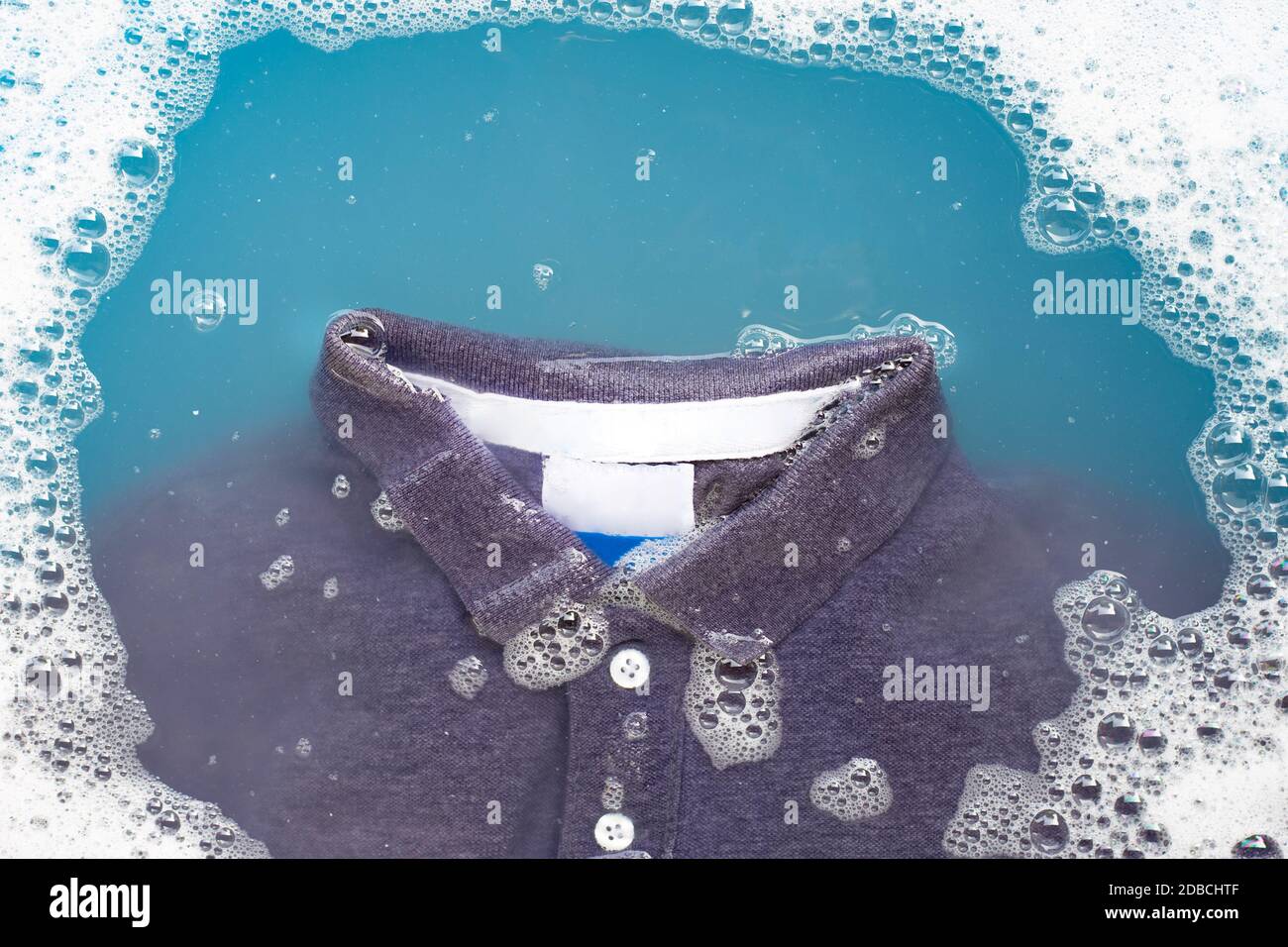 Polo shirt soak in powder detergent water dissolution, washing cloth ...