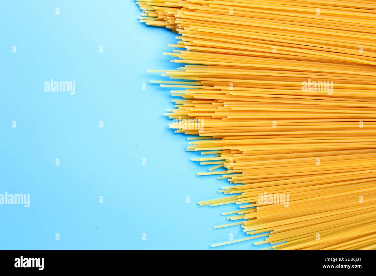 Long spaghetti on blue hi-res stock photography and images - Alamy