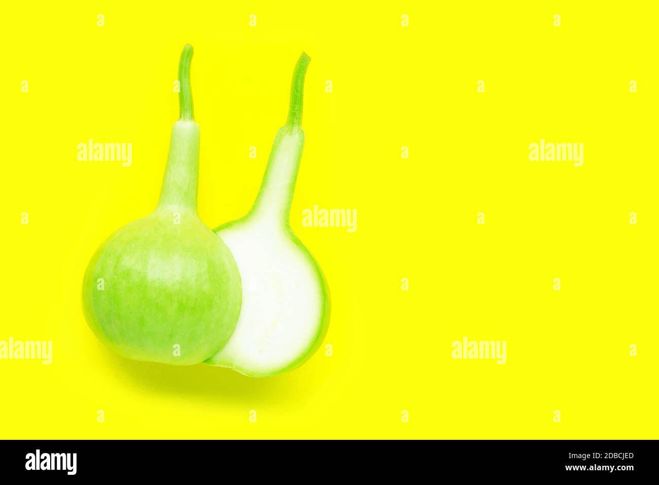 Calabash, Bottle Gourd fruit yellow background. Copy space Stock Photo ...