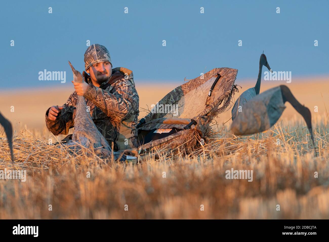 A hunter with a Sandhill Crane Stock Photo - Alamy