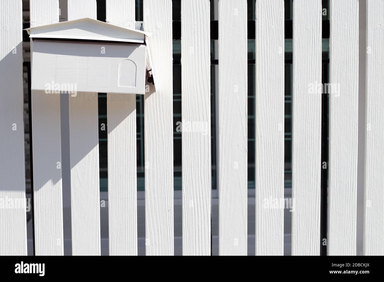 White post box on white wooden fence Stock Photo - Alamy