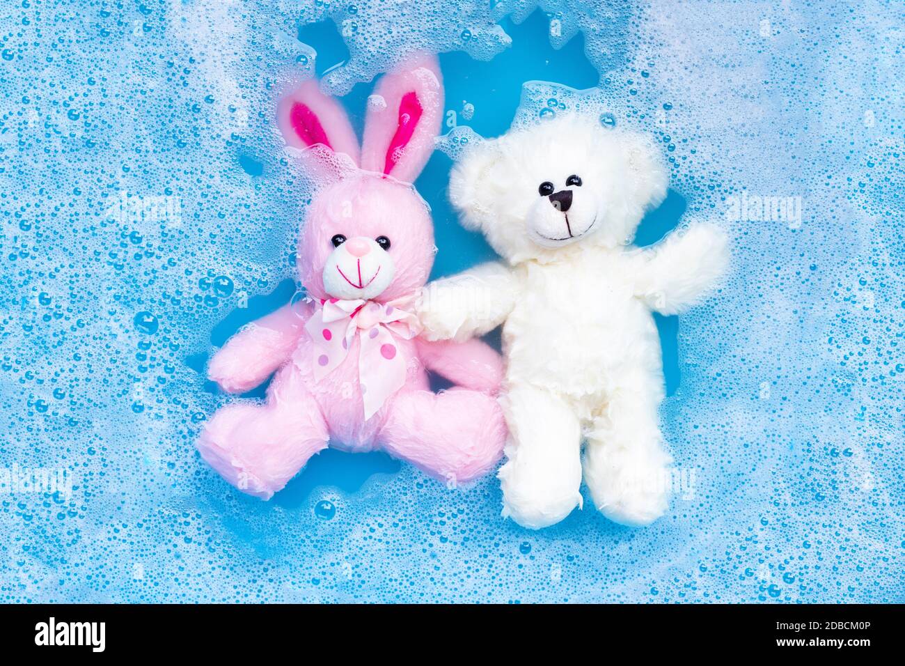 Soak rabbit doll with toy teddy bear in laundry detergent water ...
