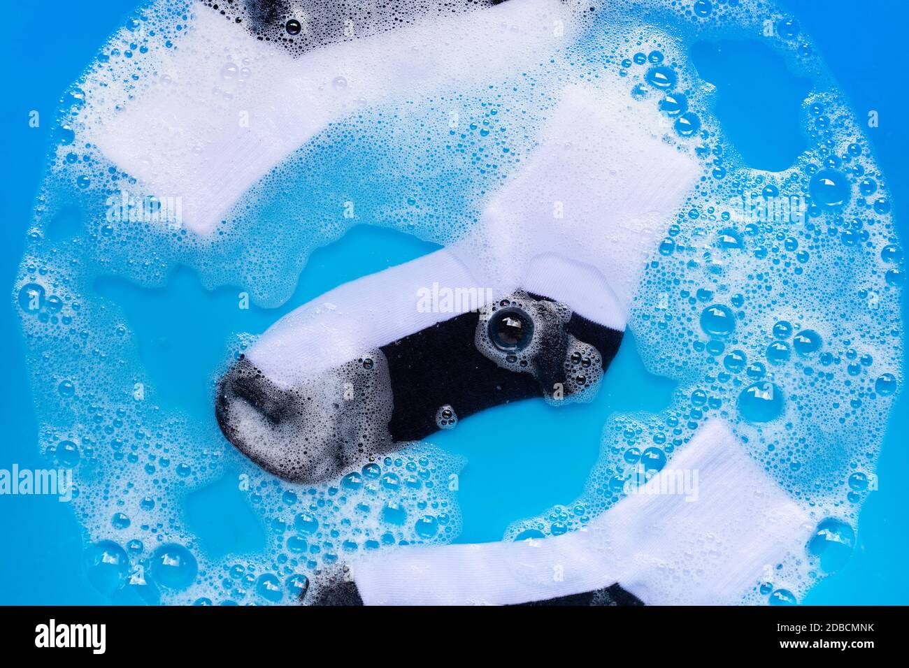 Dirty socks soaking in powder detergent water dissolution. Laundry ...