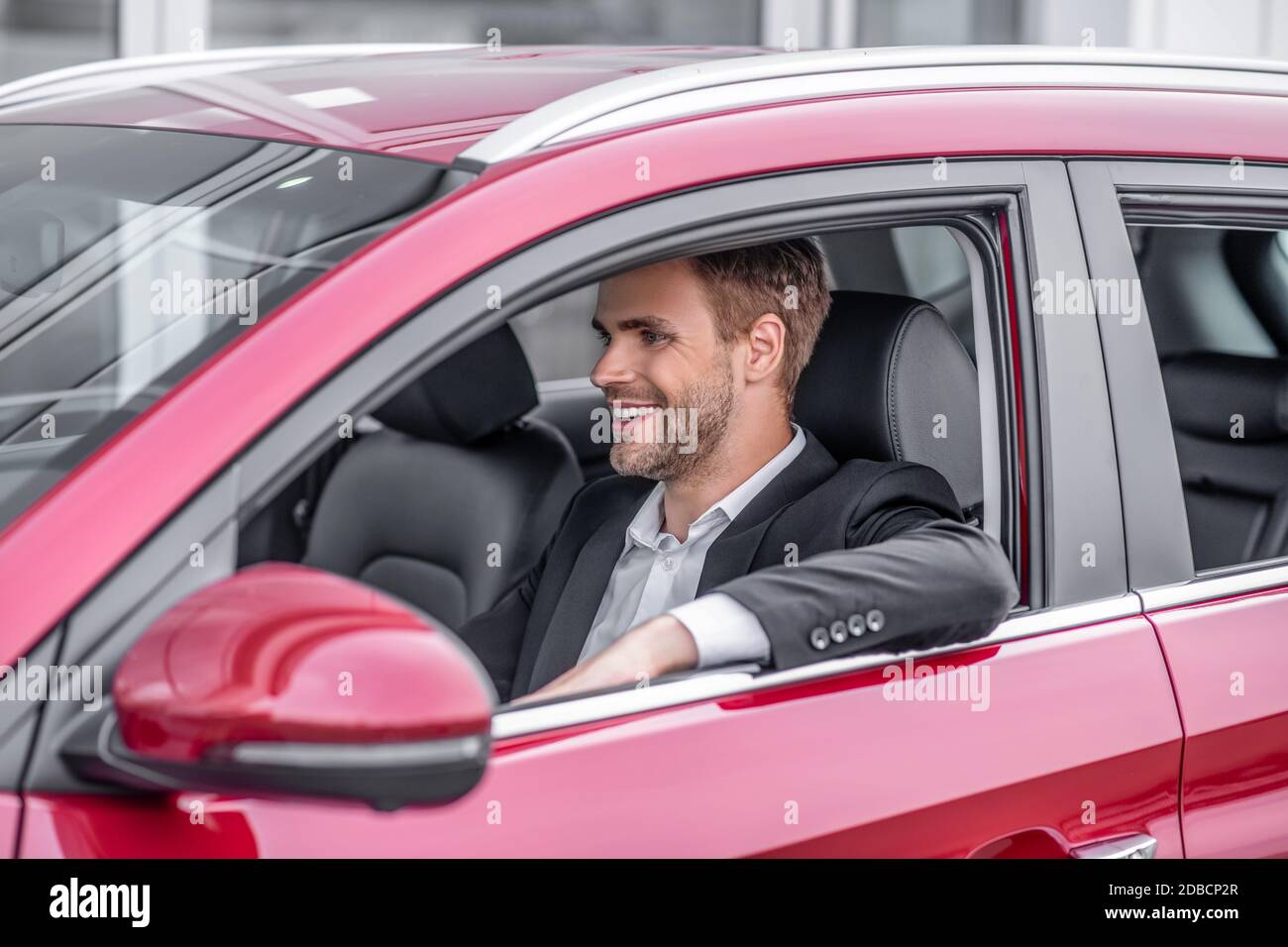 Black man sitting in car showroom hi-res stock photography and images ...