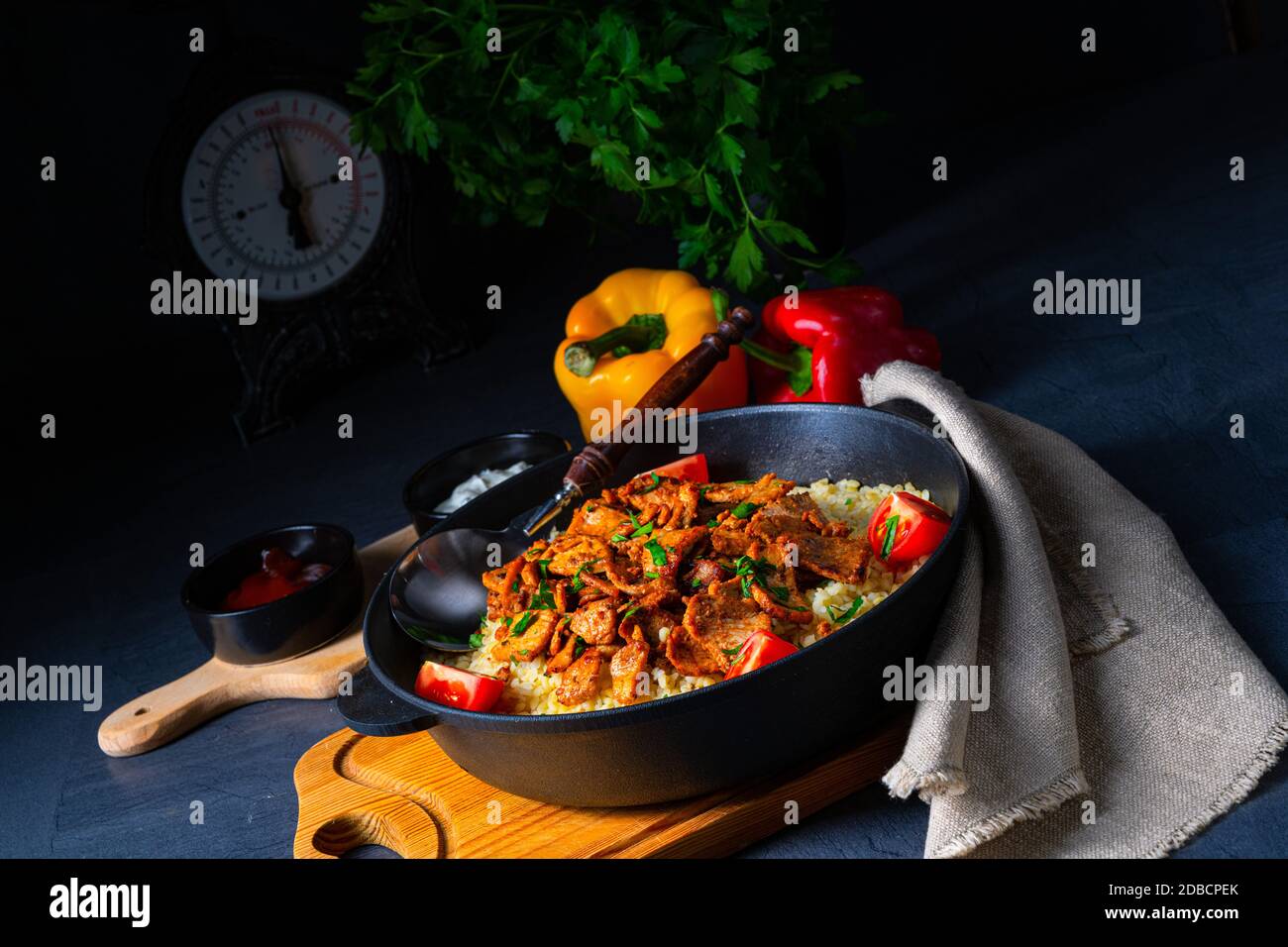 rustic bulgur pans with gratinated gyros and yoghurt Stock Photo - Alamy
