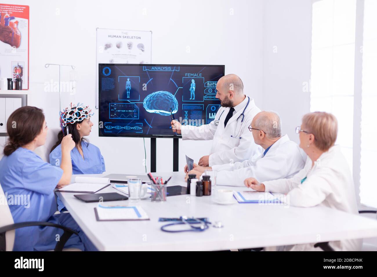 Doctor talking about brain activity during conference with medical ...