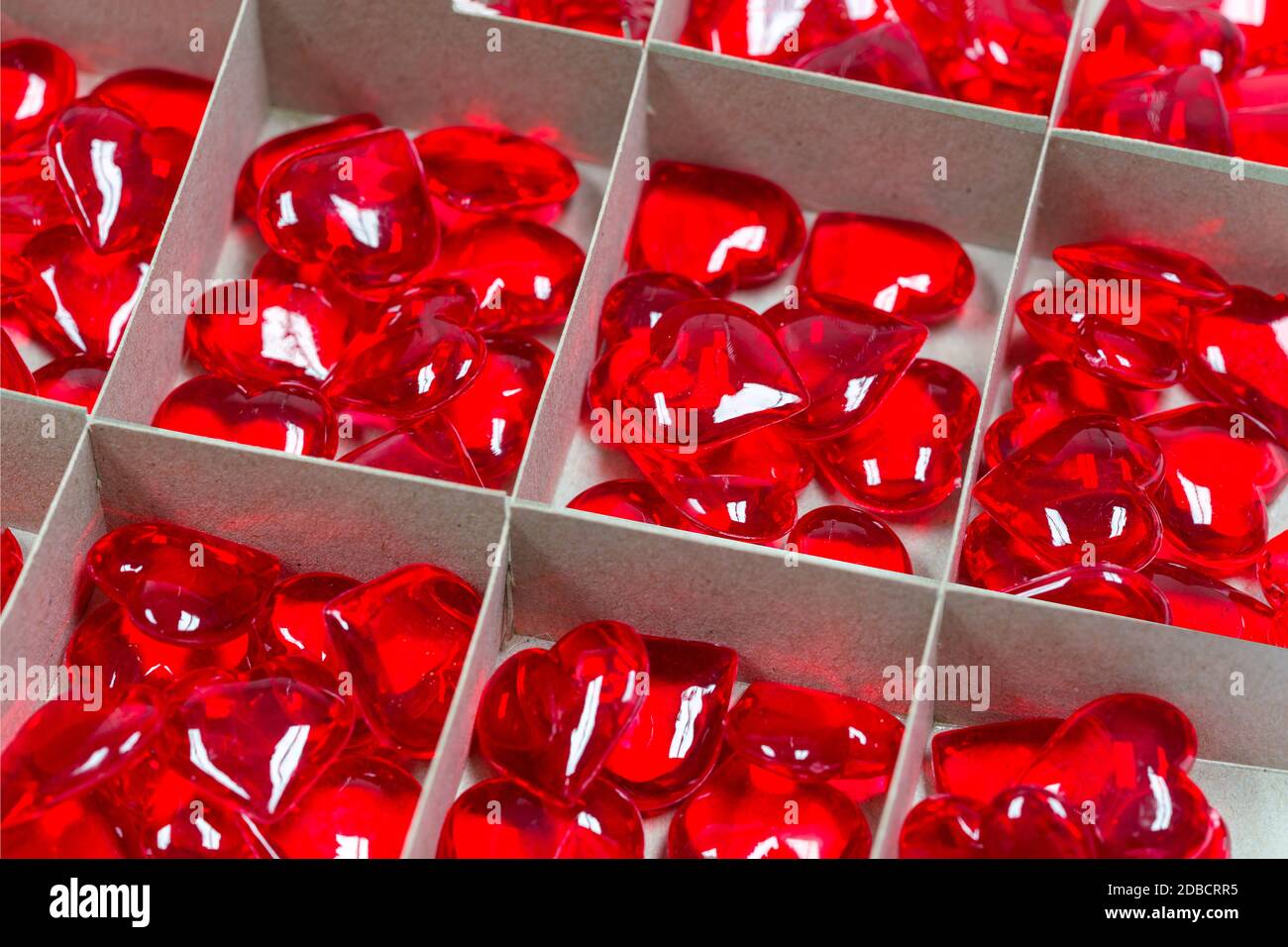 Red glass hearts in a cardboard box Stock Photo - Alamy