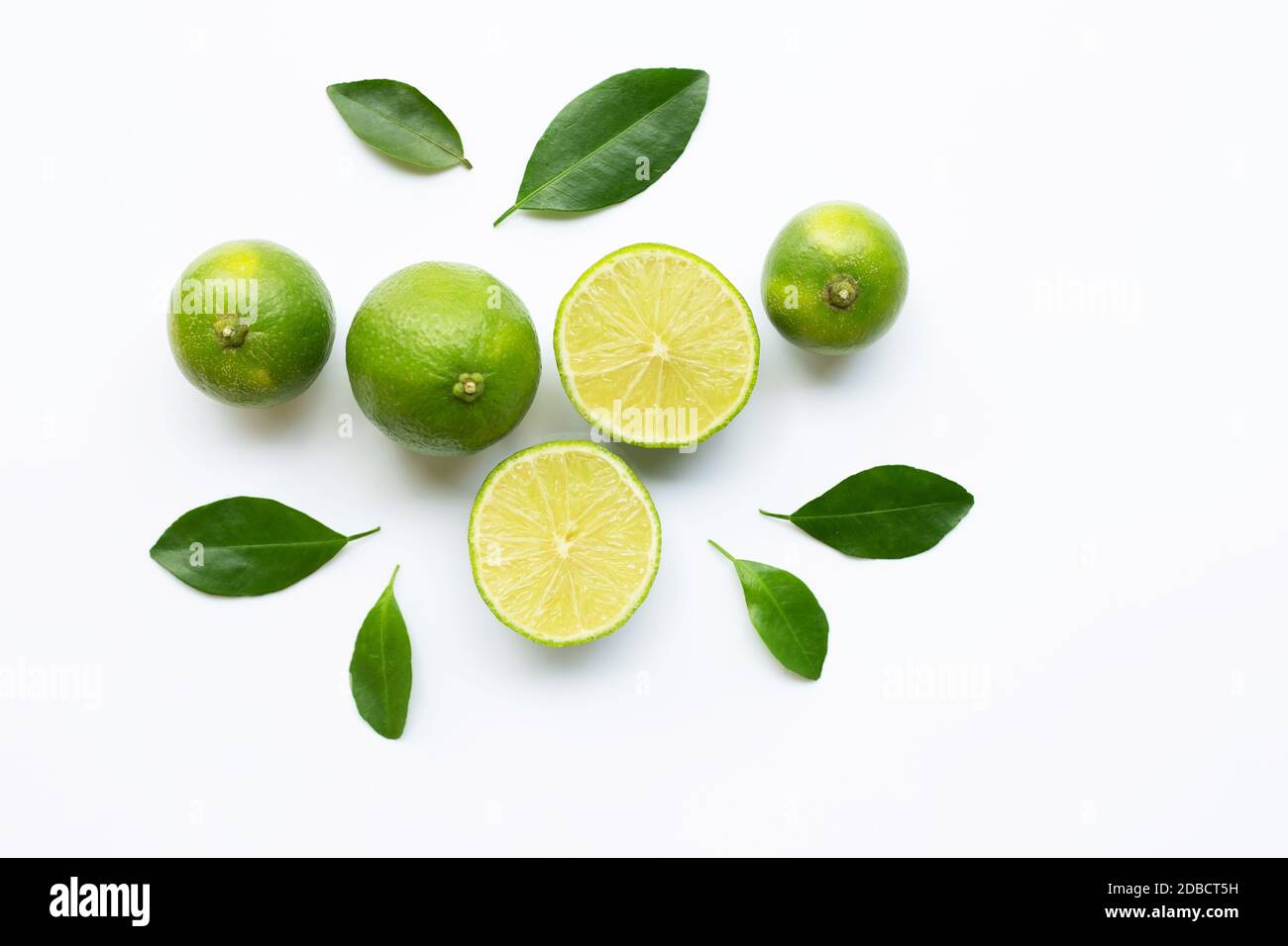 Ripe limes with green leaves on white background Stock Photo - Alamy