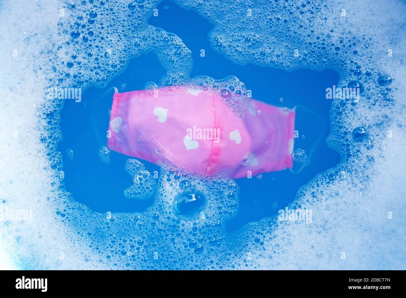 Cloth mask soak in powder detergent water dissolution before washing ...