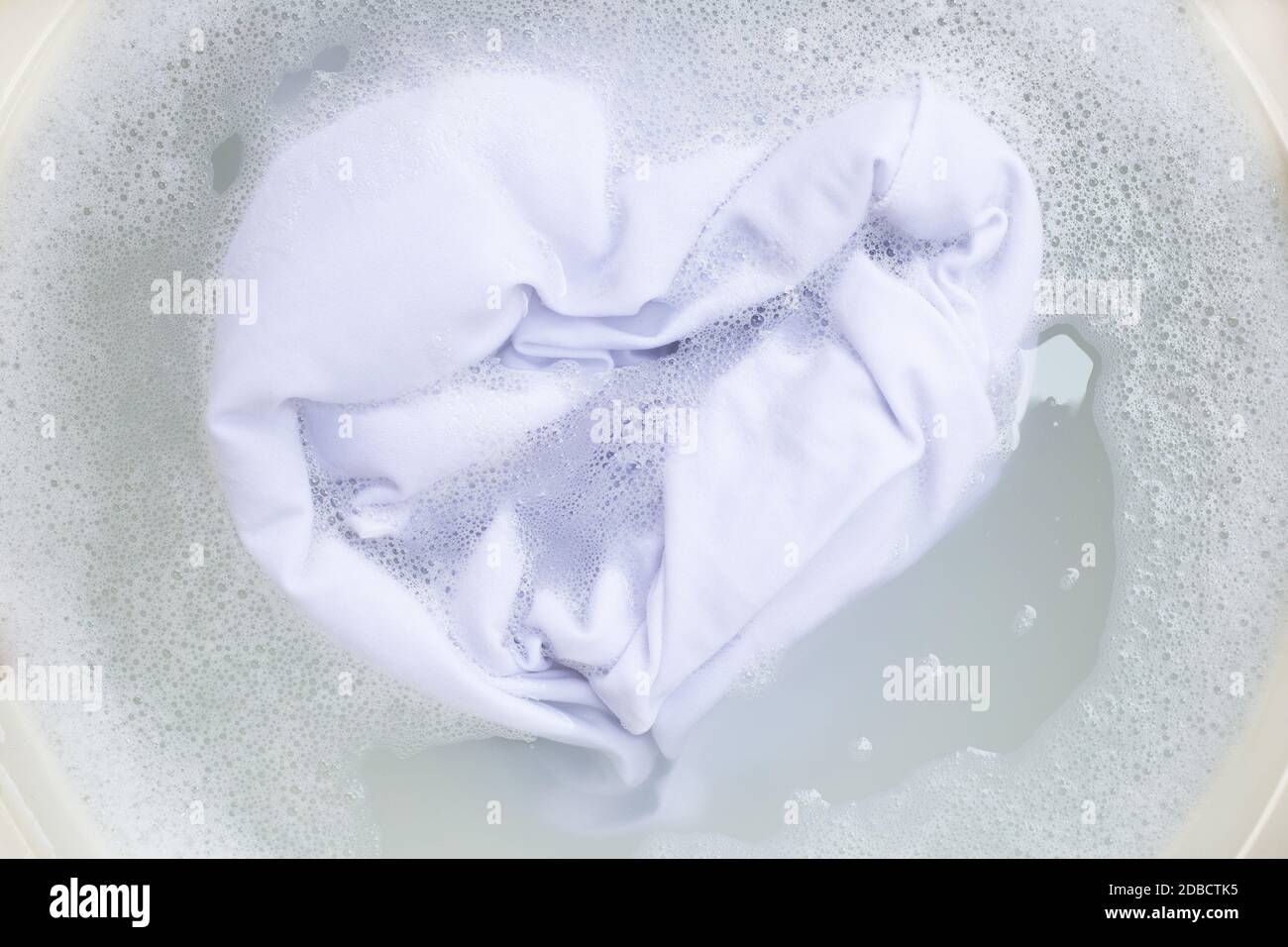 Soak a cloth before washing, white cloth. Top view Stock Photo - Alamy