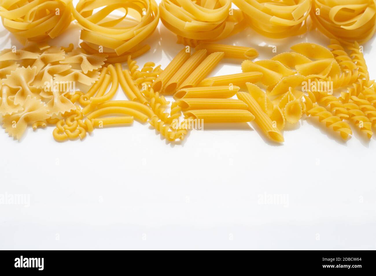 Different types of dry pasta on white background Stock Photo - Alamy