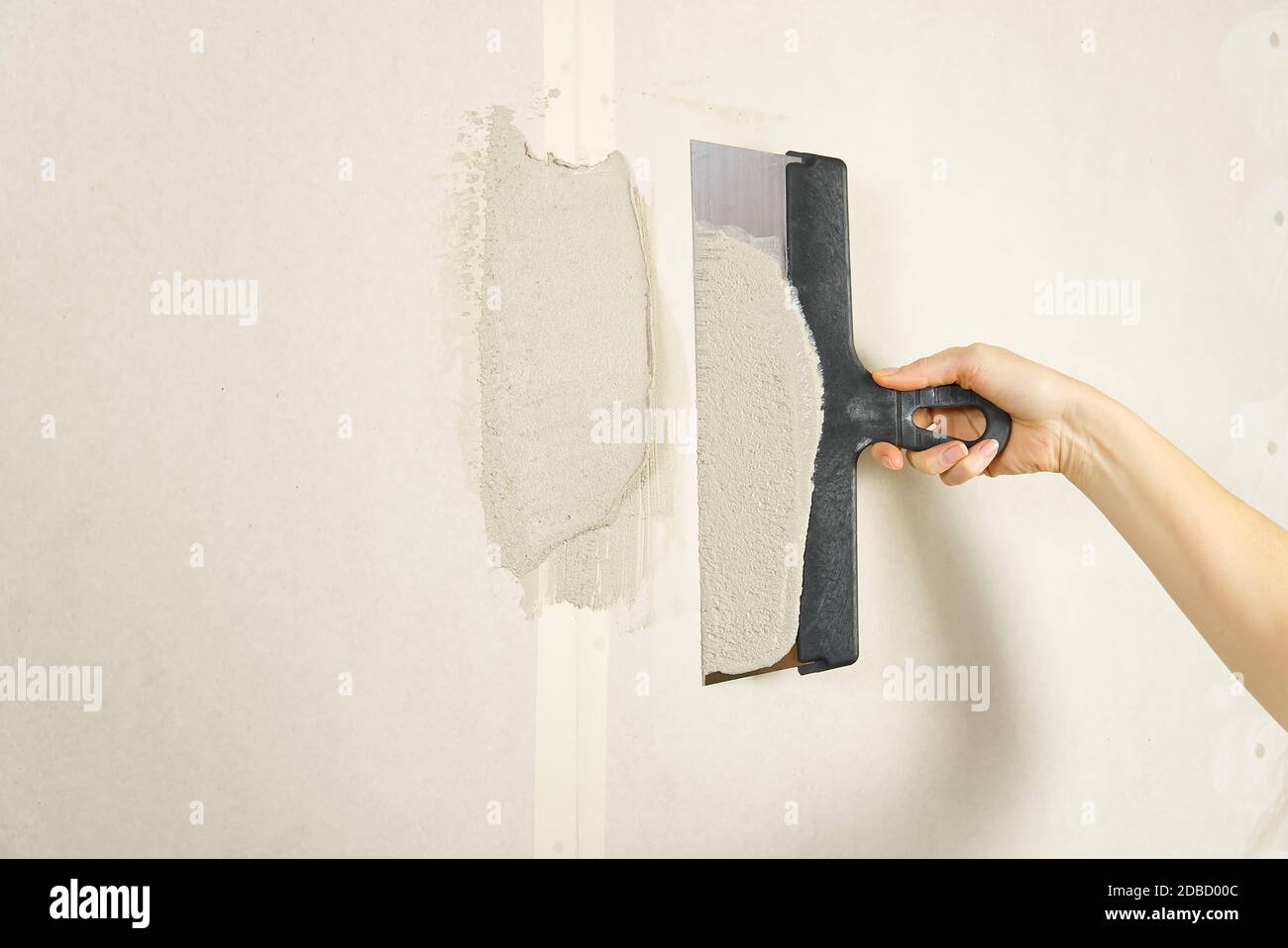 Woman putty wall hi-res stock photography and images - Alamy