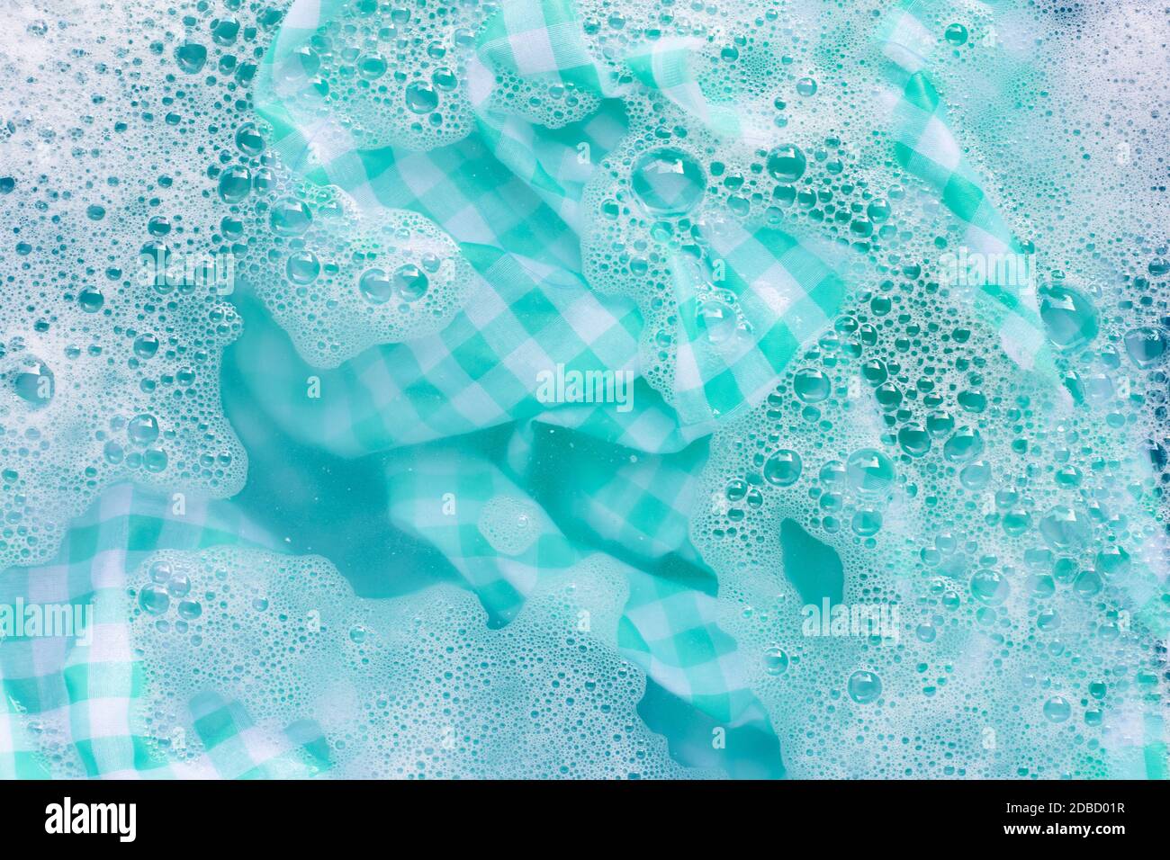 Green white tablecloth soak in powder detergent water dissolution ...