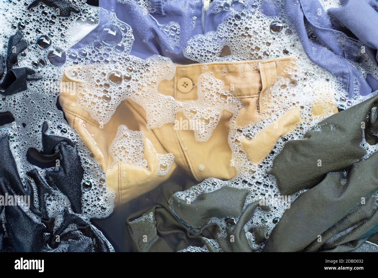 Trousers soak in powder detergent water dissolution, washing cloth ...