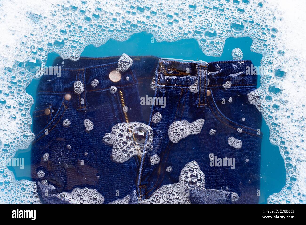 Jeans soak in powder detergent water dissolution, washing cloth ...