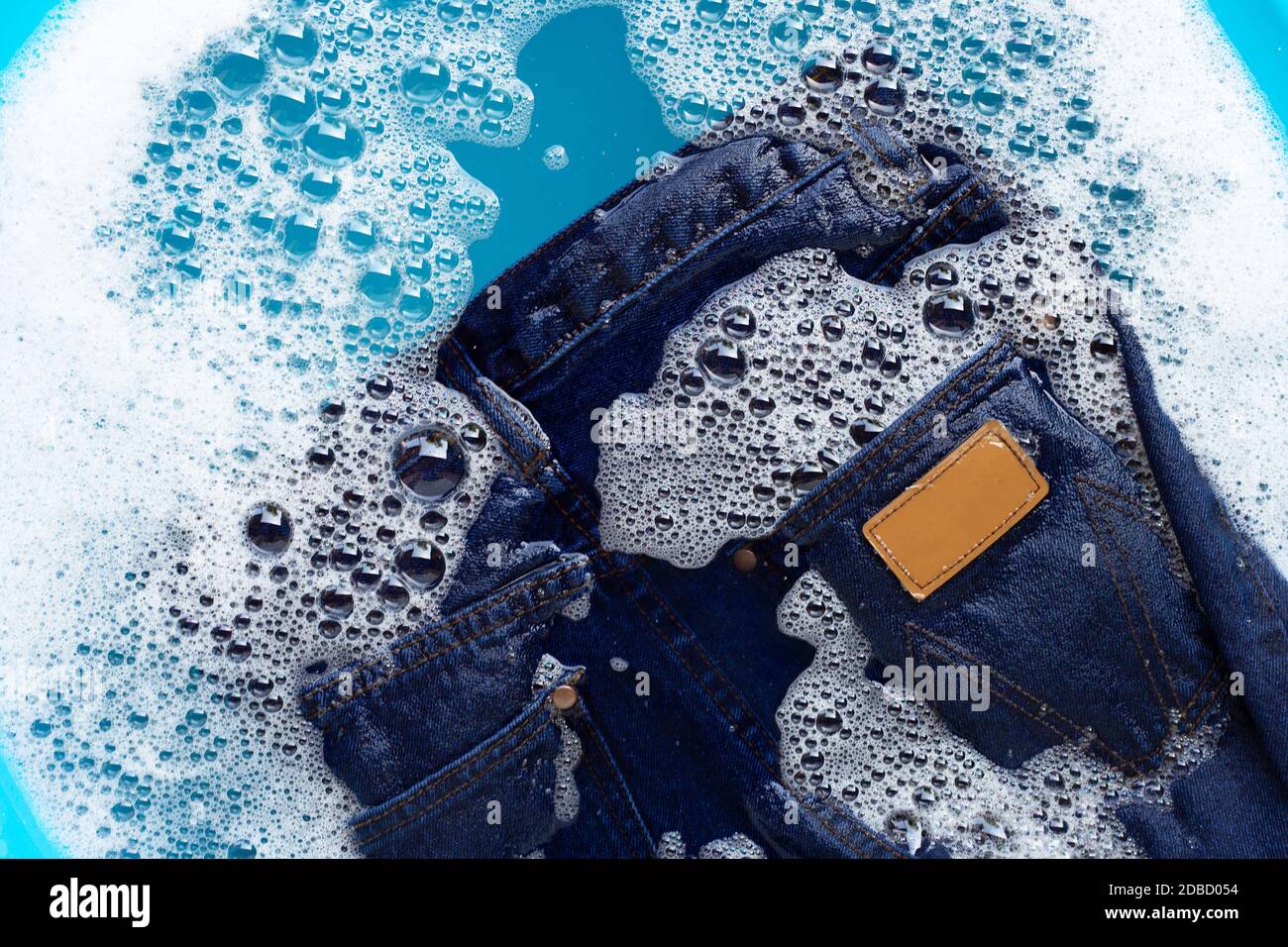Jeans soak in powder detergent water dissolution, washing cloth ...