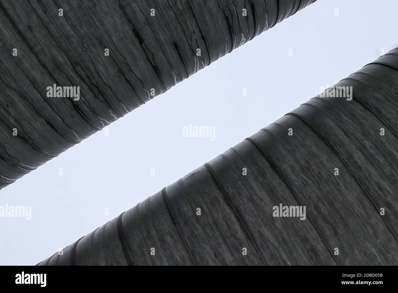 Two metal pipes with clearance background Stock Photo - Alamy